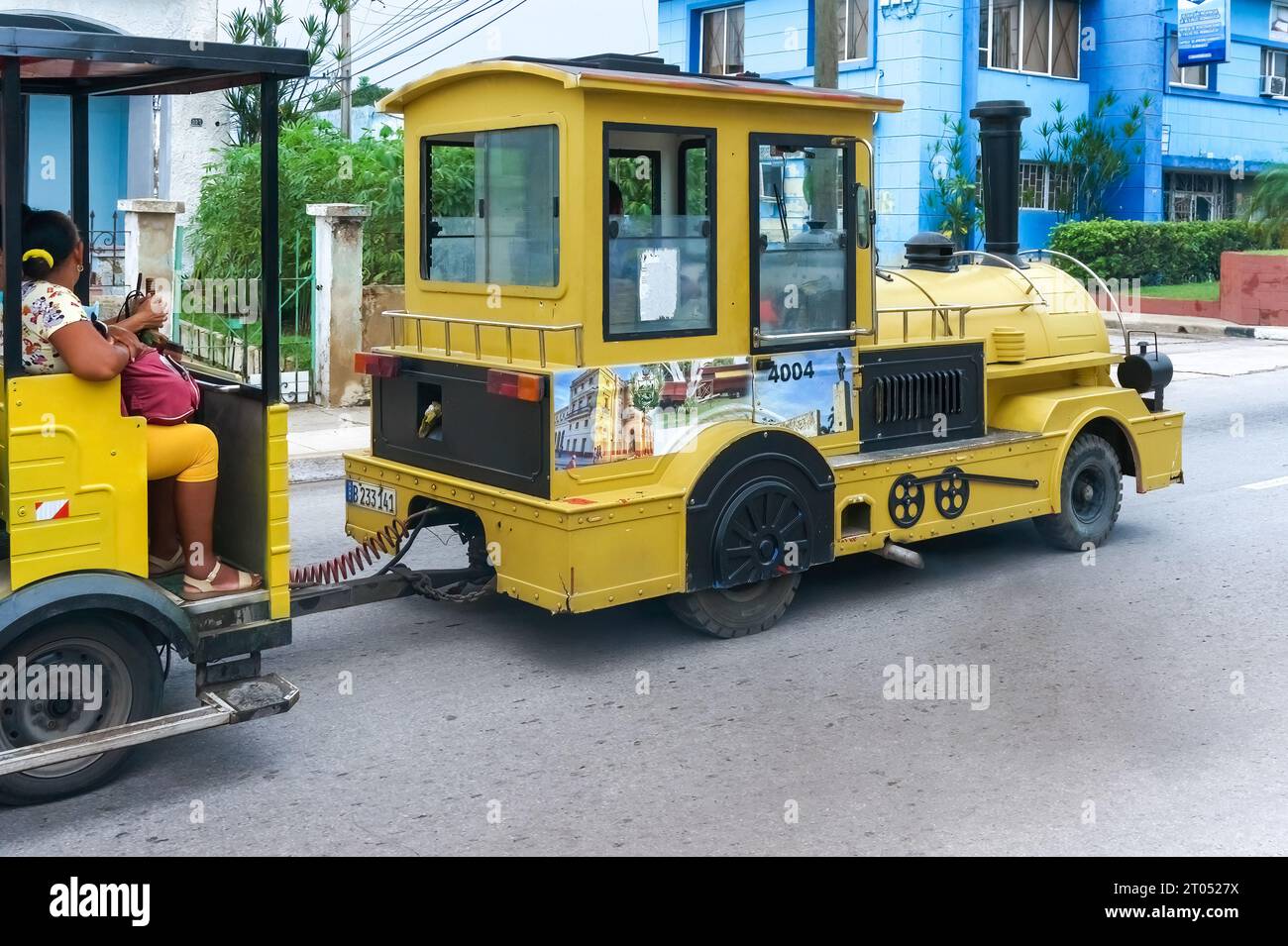 Real people on a motor vehicle with the resemblance of a vapor train ...