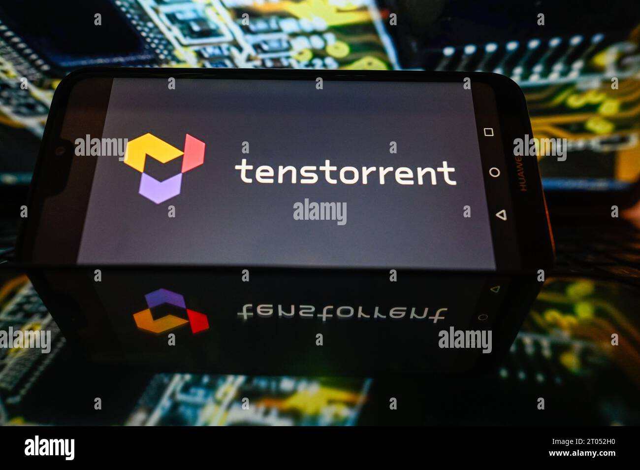In this photo illustration, Tenstorrent logo seen displayed on a smartphone with tech hardware ...