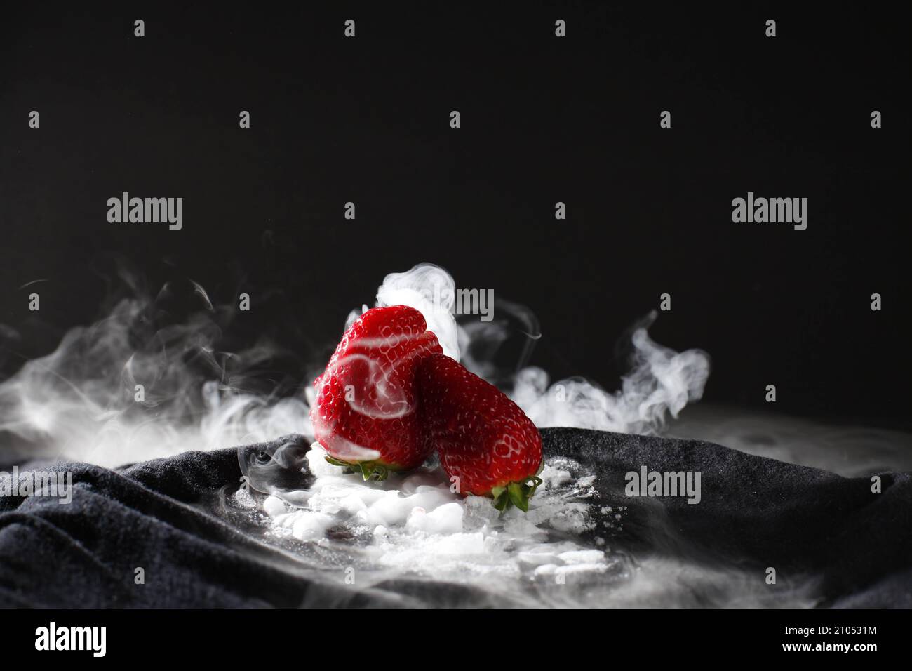 Fresh red strawberries with dry ice smoke and black background Stock ...