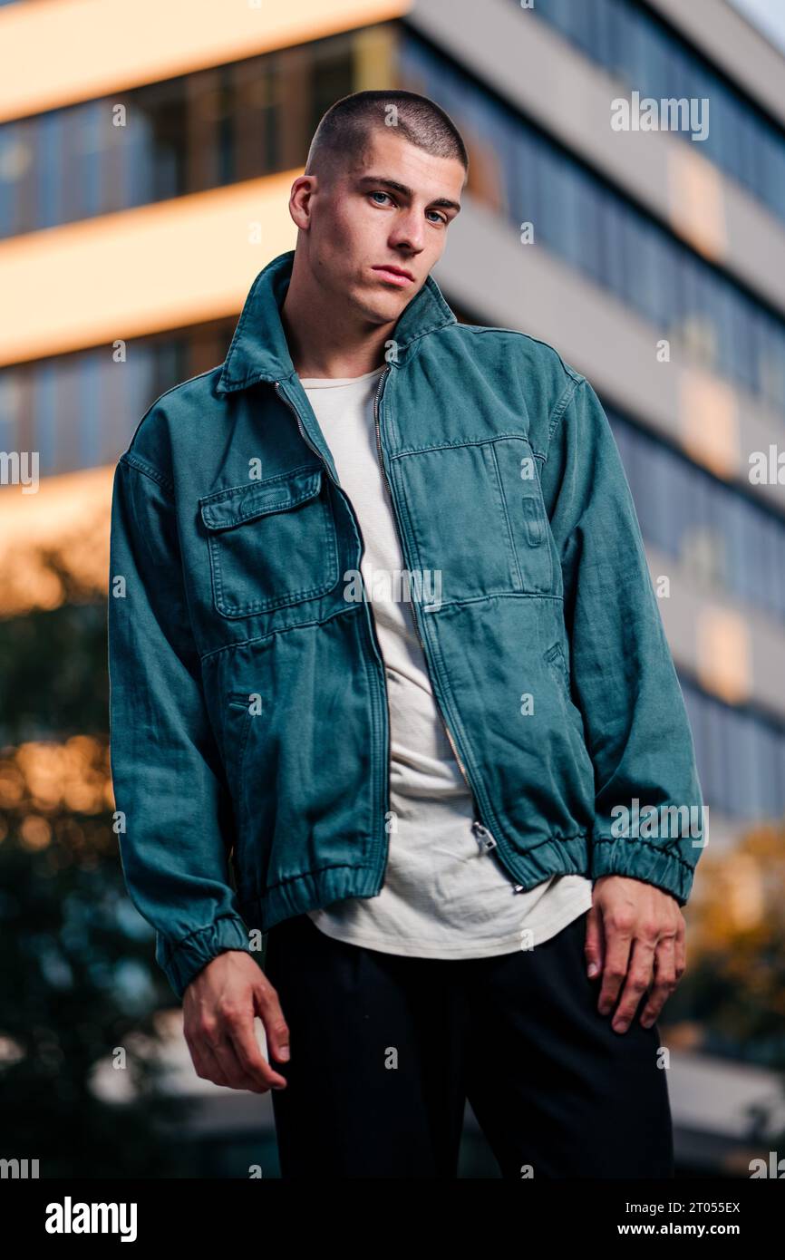 A young Caucasian male model posing in a denim jacket Stock Photo - Alamy