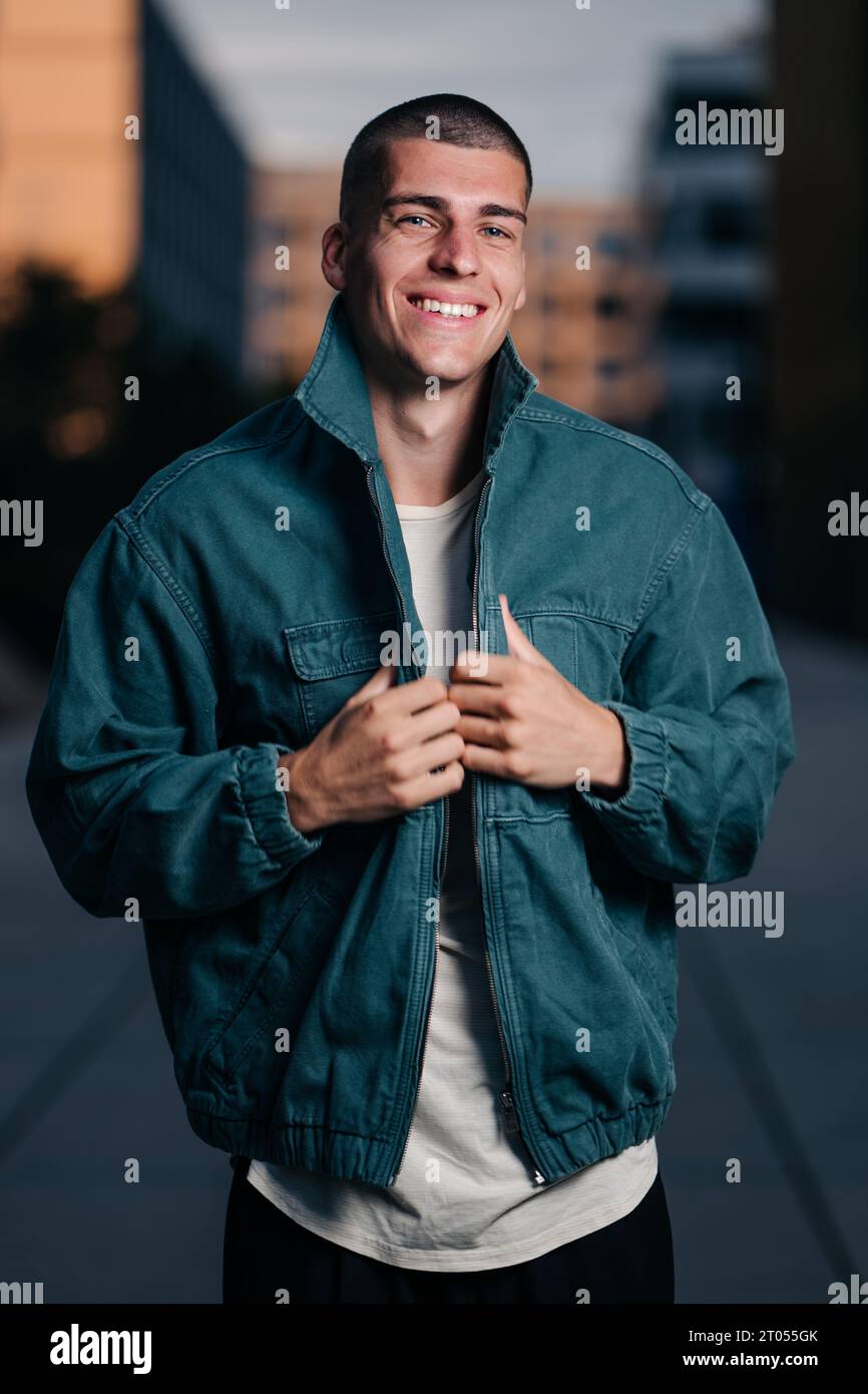 A young Caucasian male model posing in a denim jacket Stock Photo - Alamy