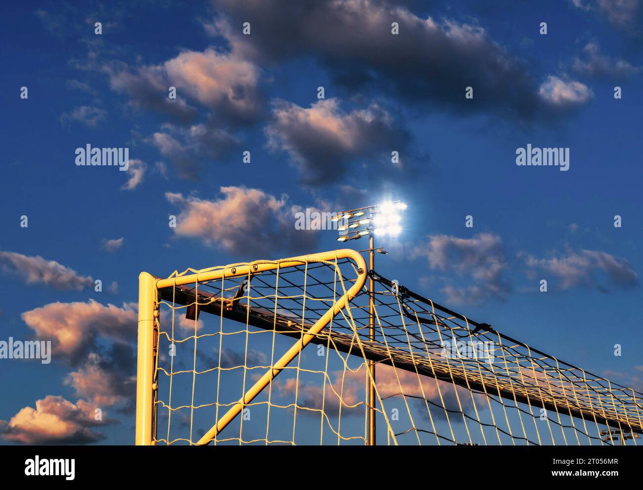 Stadium lights in a sky with clouds behind the goal Stock Photo - Alamy