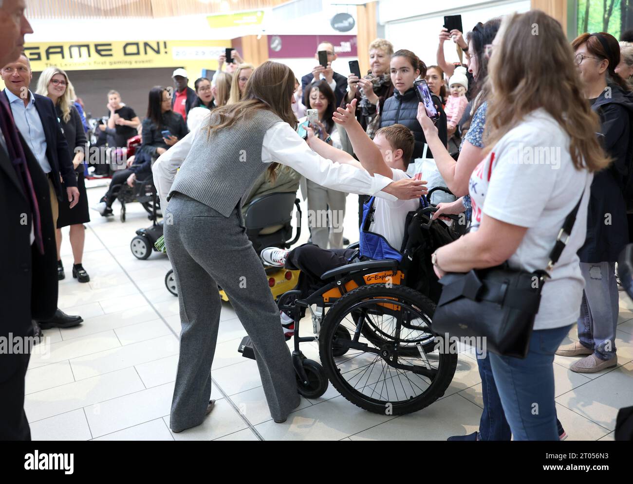 The Princess of Wales hugs a well-wisher in a wheelchair during a visit ...