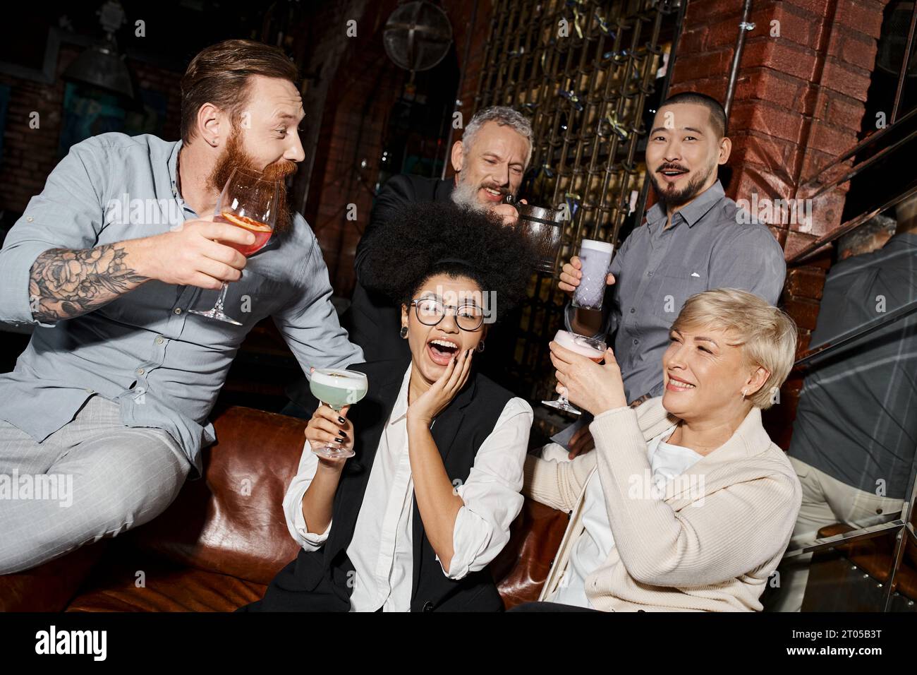 excited african woman laughing near multicultural work friends relaxing ...