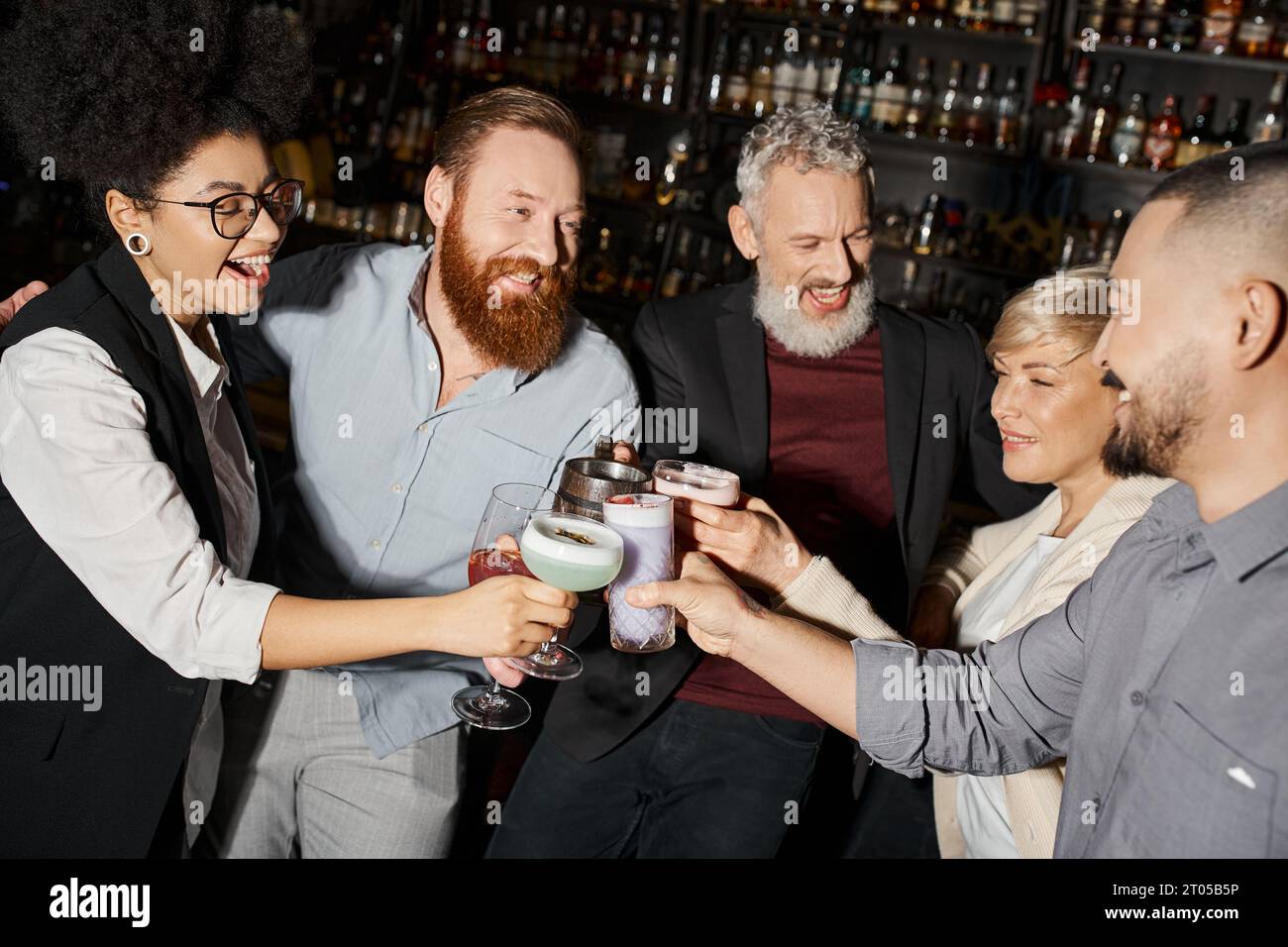 corporate party in cocktail bar, joyful multiethnic colleagues clinking ...