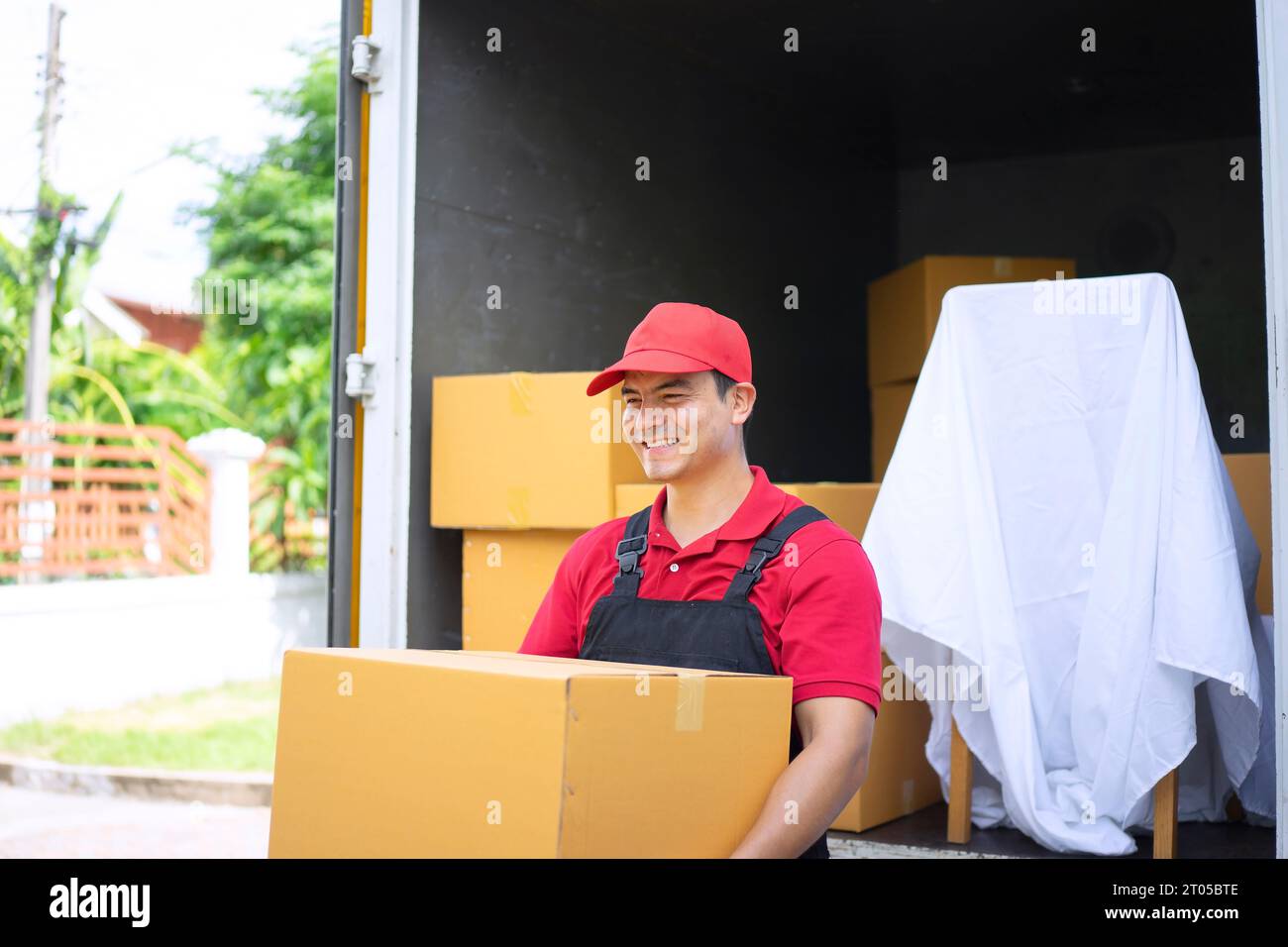 Delivery man move items to the house. Service and delivery concept ...