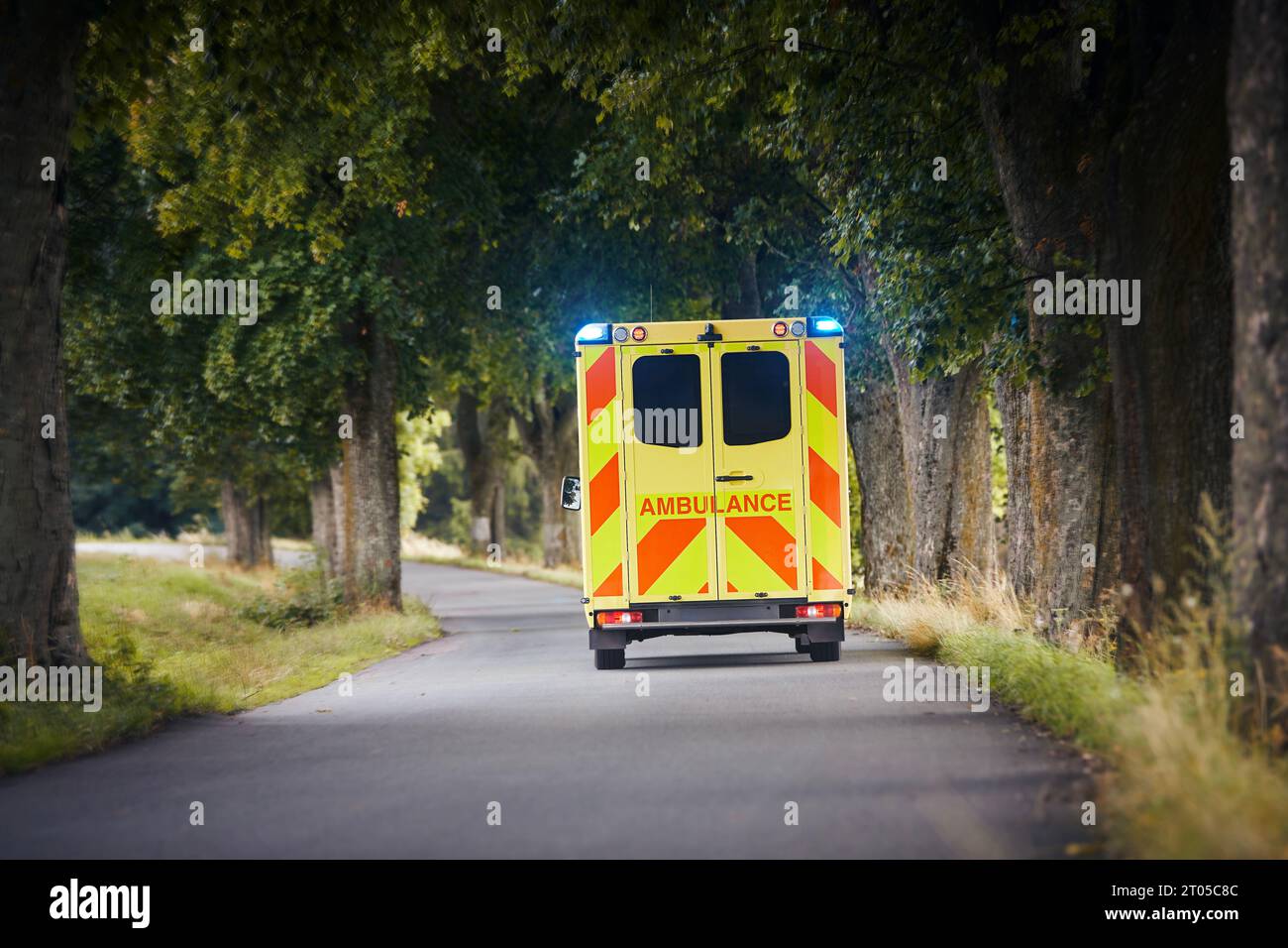 Yellow ambulance car of emergency medical service on country road ...