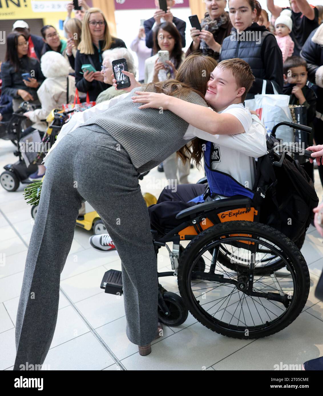 The Princess of Wales hugs a well-wisher in a wheelchair during a visit ...