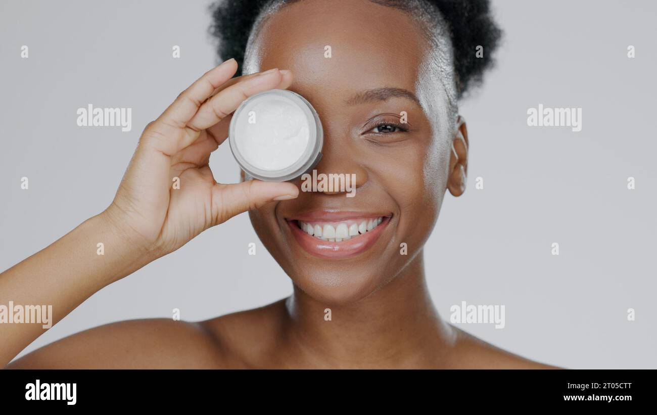 Happy black woman, face and skincare cream for beauty, cosmetics ...