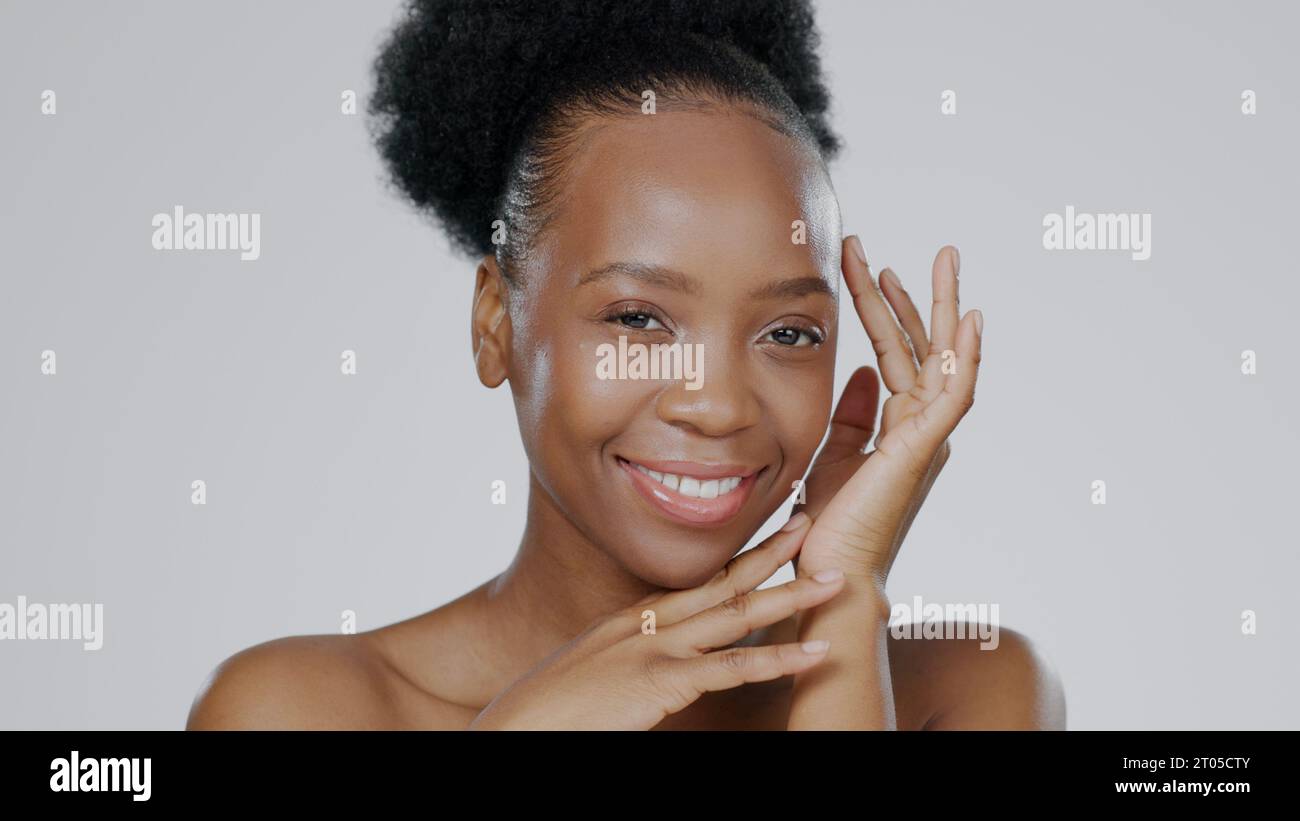 Face touch, skincare and happy black woman in studio isolated on a gray background mockup space ...