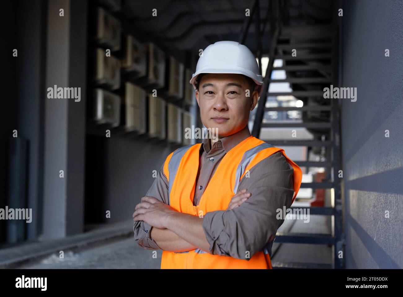 Close-up portrait of young Asian man, construction company worker ...
