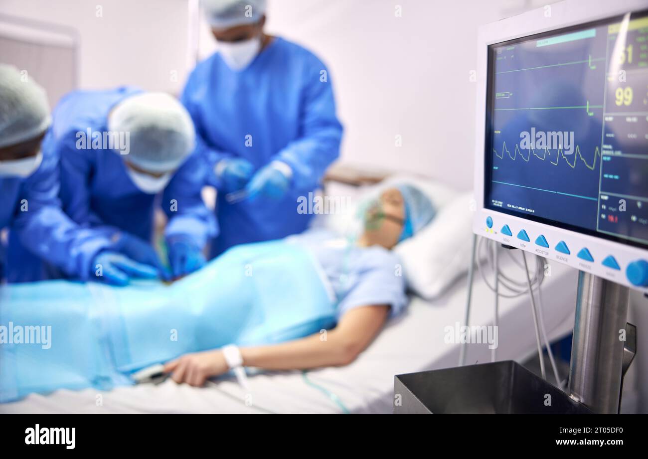 Monitor, surgery and doctors team doing emergency operation for organ ...
