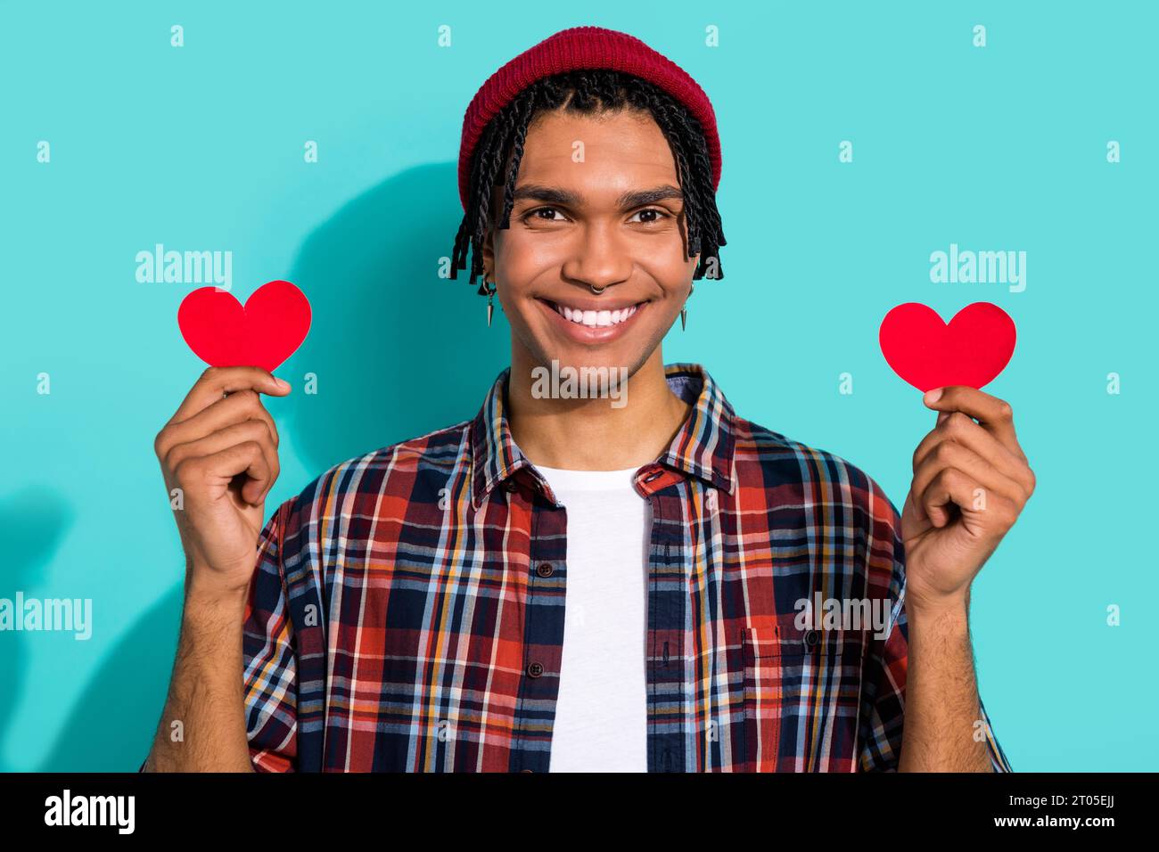 Photo portrait of nice young guy hold two red cards boyfriend smile ...