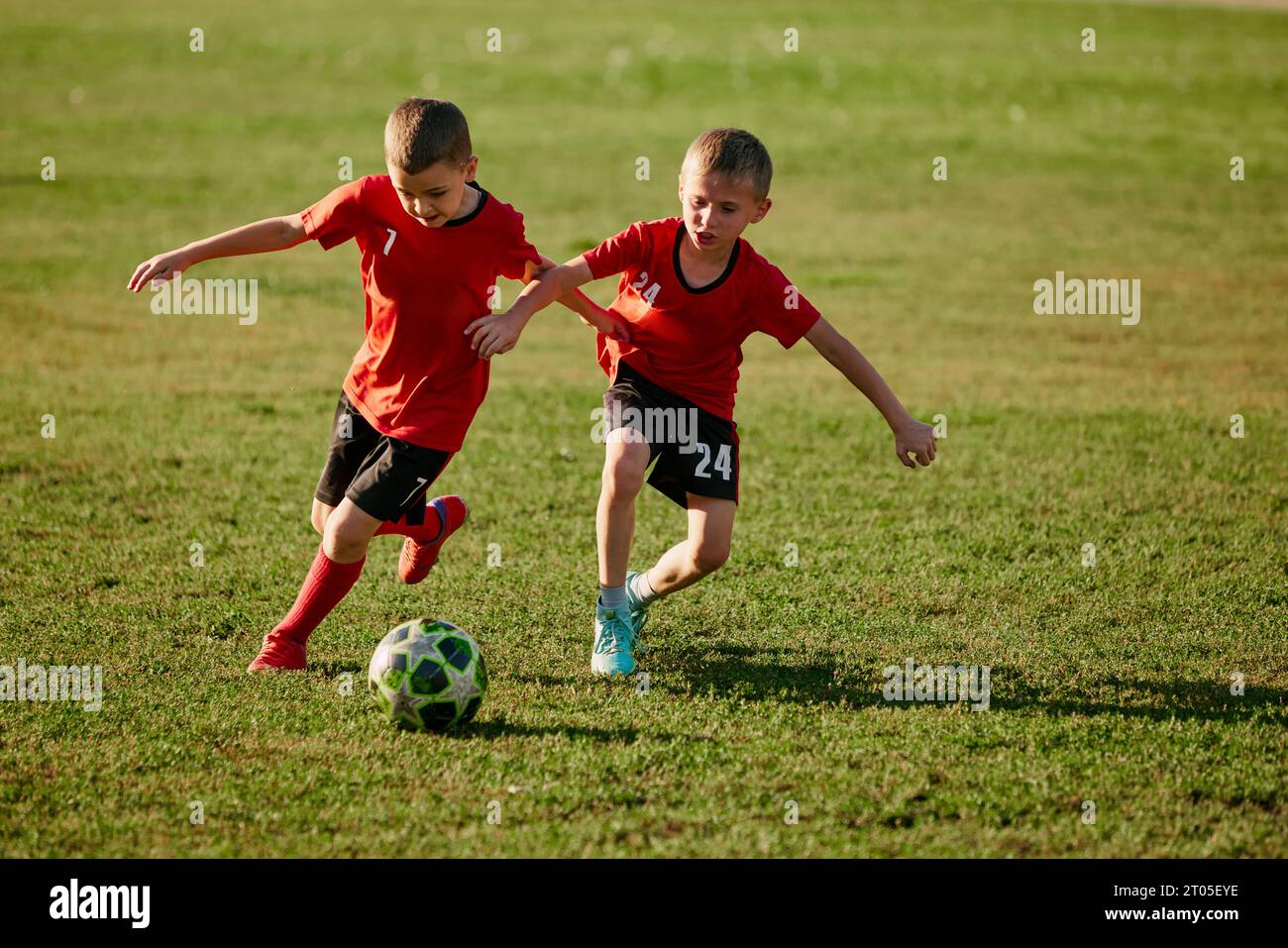 Full length portrait of kid soccer players on match in motion. Playing ...