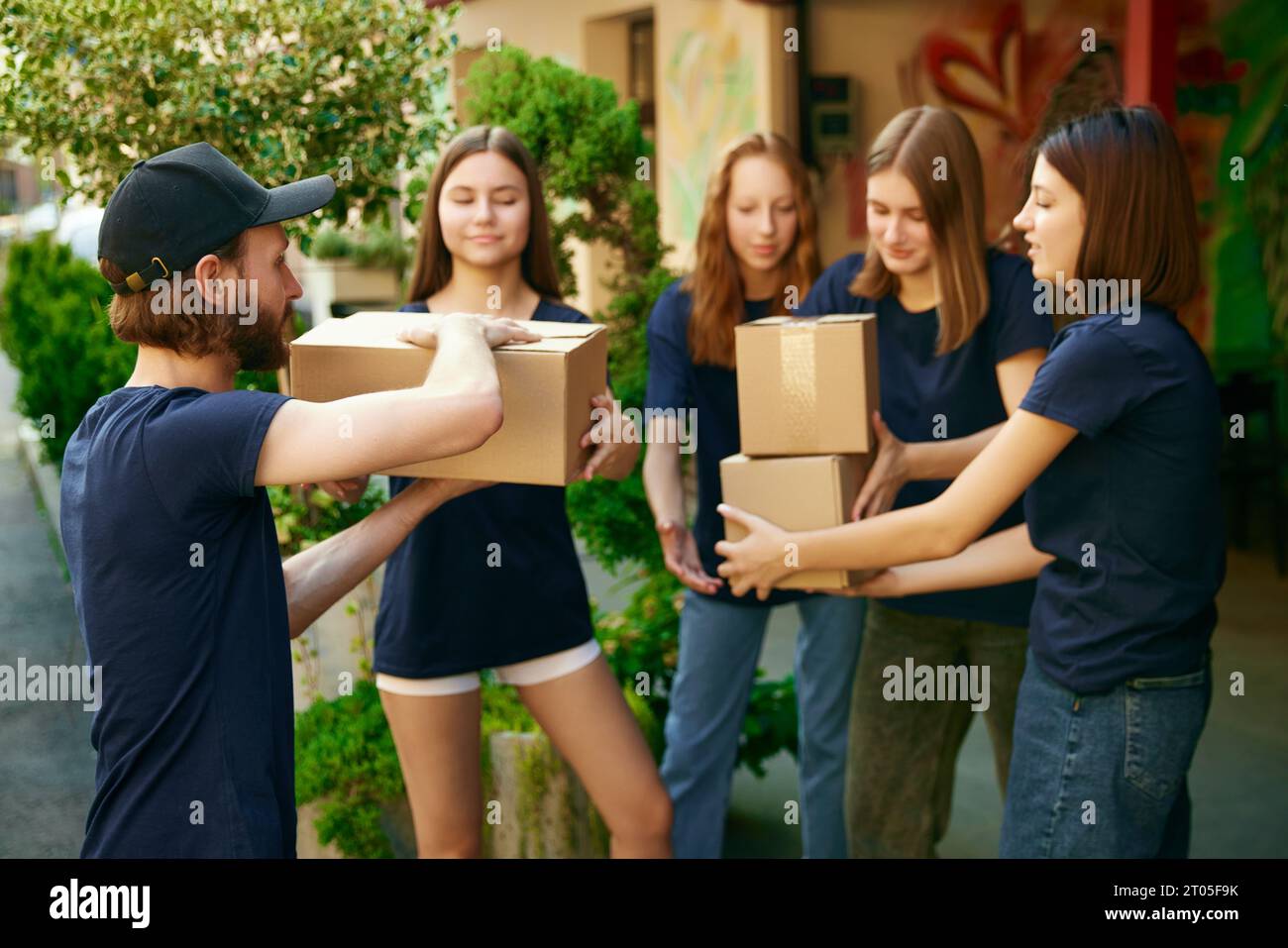 Helpful young people, volunteers gathering humanitarian help for people ...