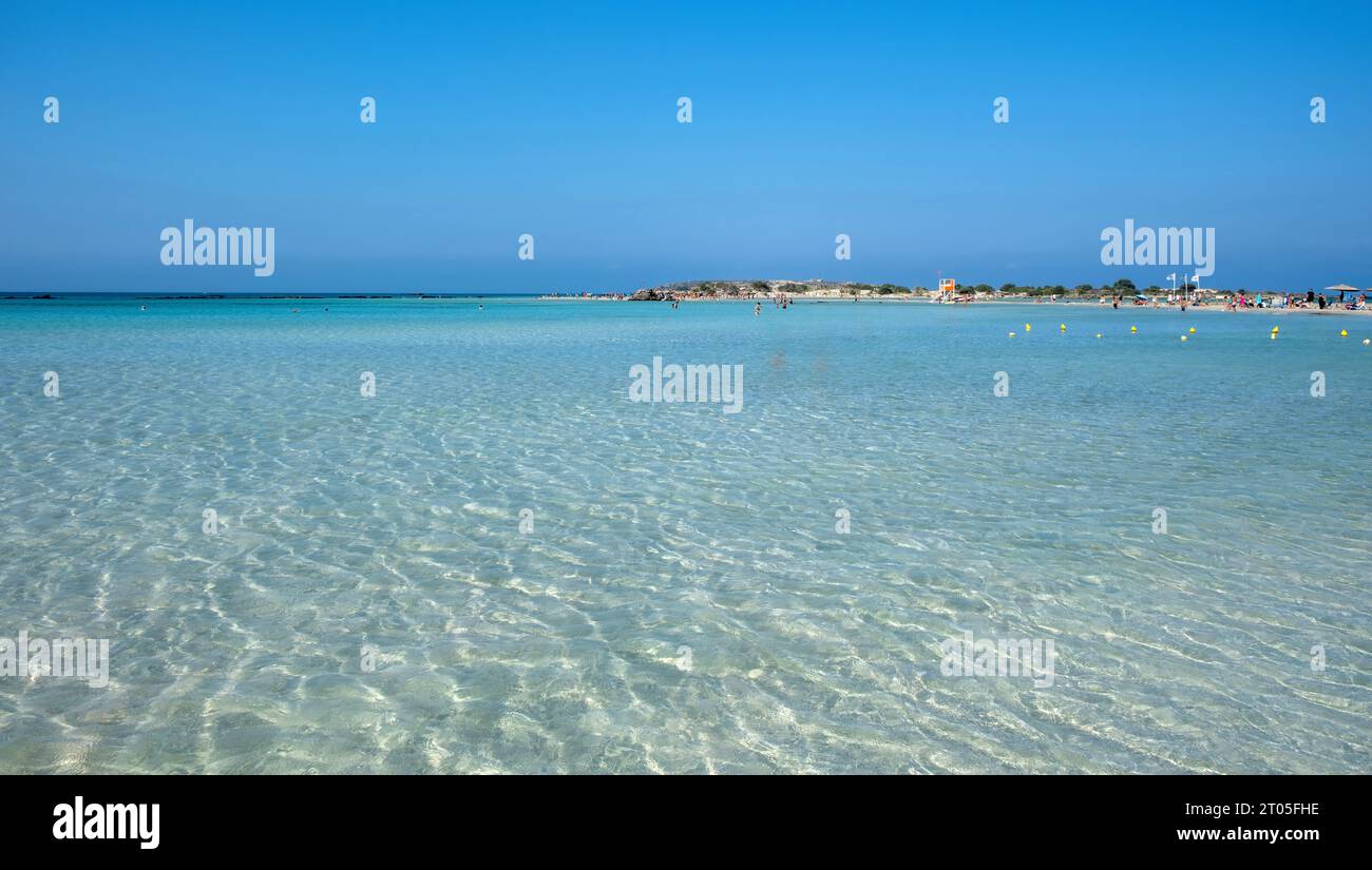 Greece Elafonisi, Crete. People swim in transparent calm sea, clear ...
