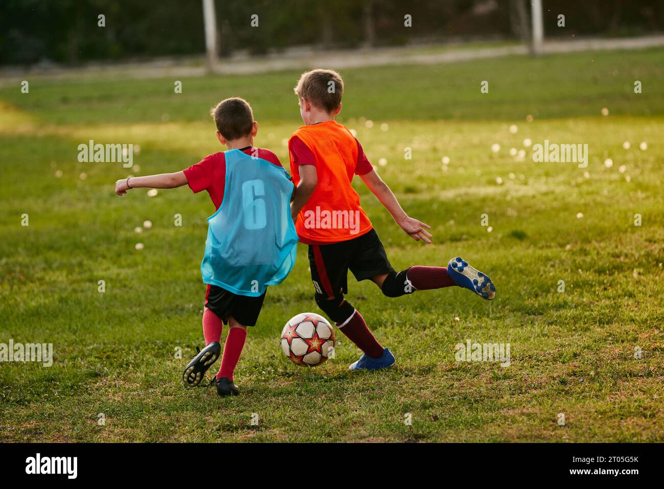 Back view competitive boys, player running wearing sport uniform in ...