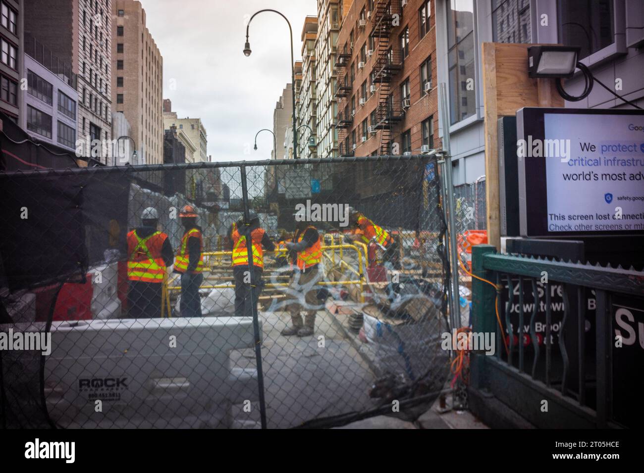 Workers renovate an entrance to the West 14th Street IND subway station ...