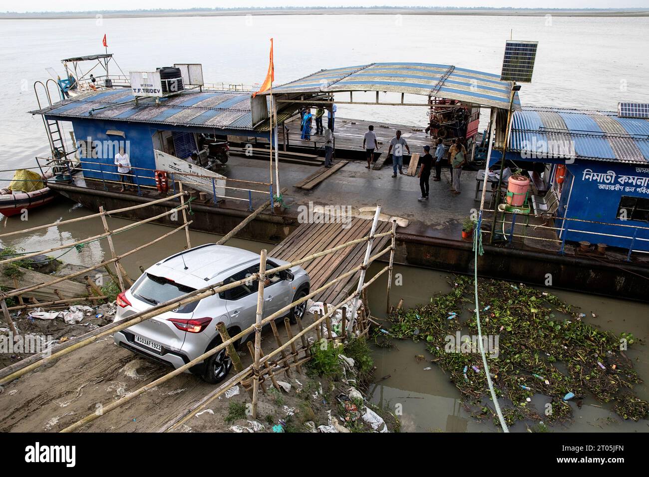 Car driving onto small ferry boat crossing Brahmaputra River to Majuli Island, Assam, India ...