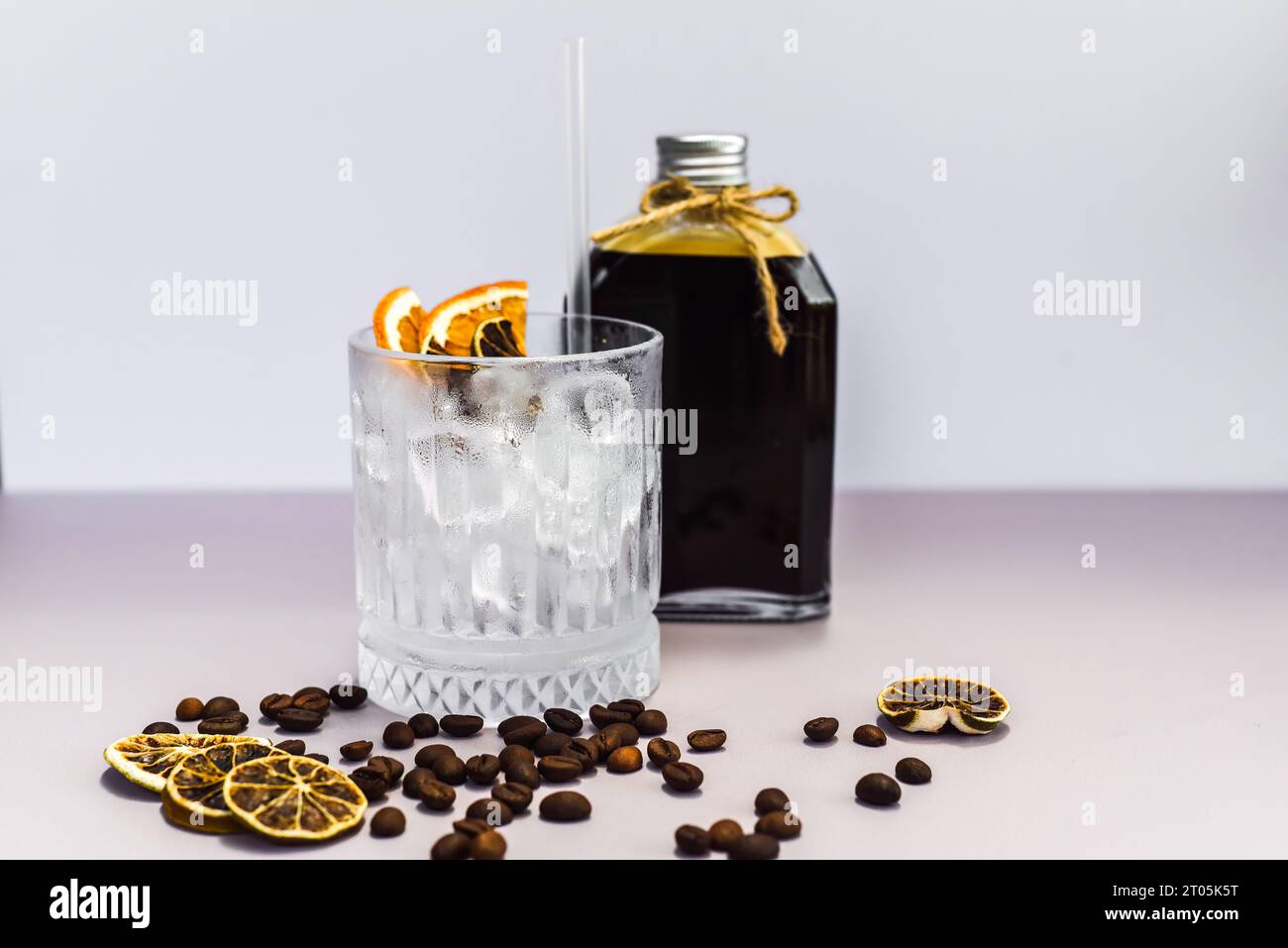 Cold brew coffee in a bottle with transparent glass full of ice on ...