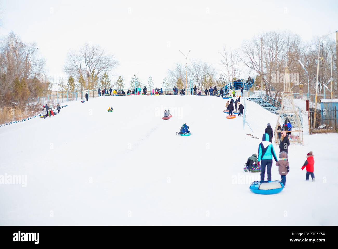 snow slide for children and adults on snow tube in urban public park ...