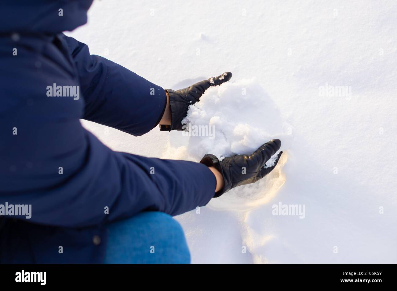 pile of snow in hands after heavy snowfall. man in gloves and winter ...
