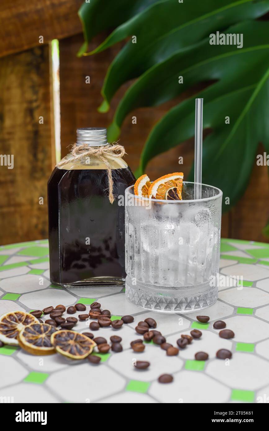 Cold brew coffee in a bottle with transparent glass full of ice on ...