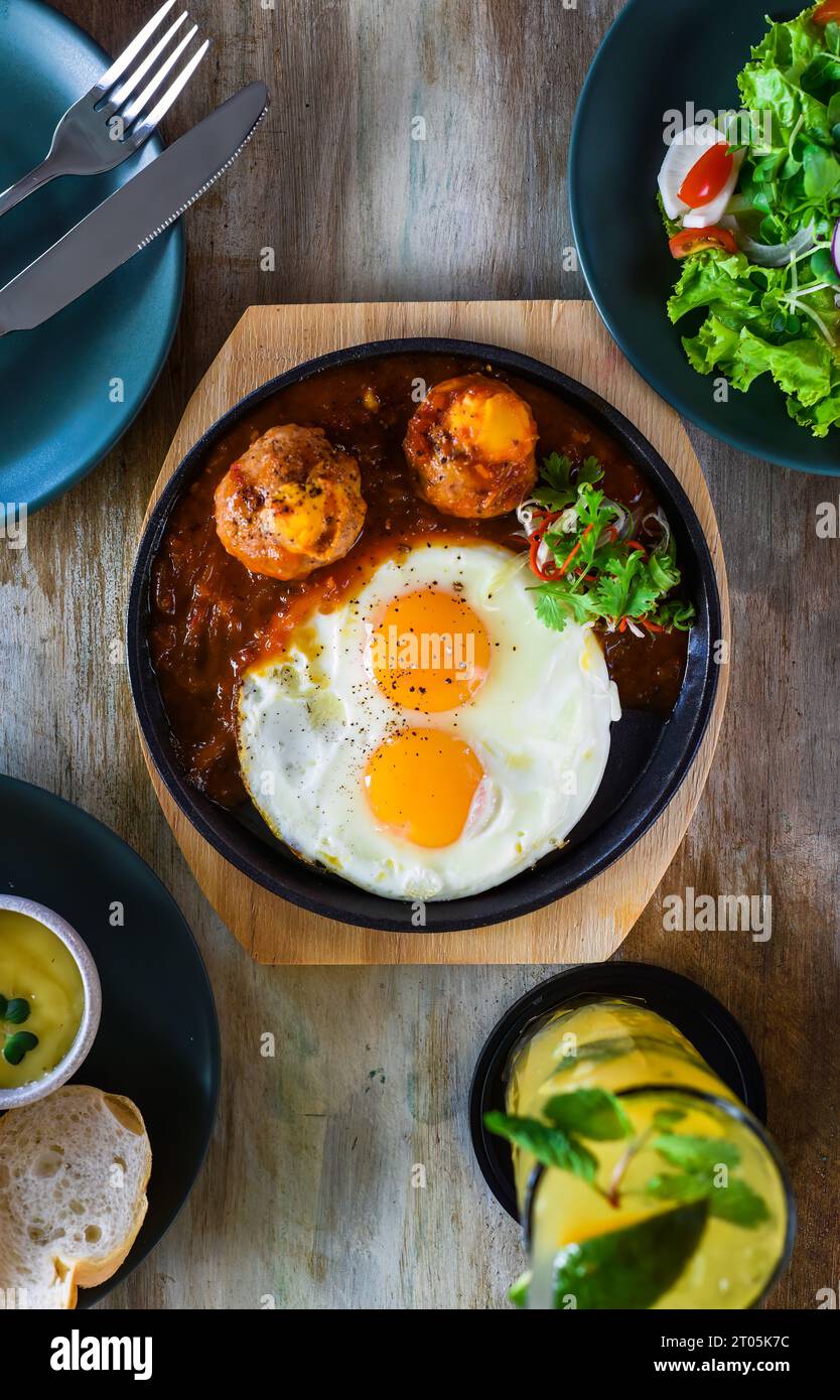 Vietnamese Banh mi chao dish with salted egg yolk meatballs, tomatoes ...