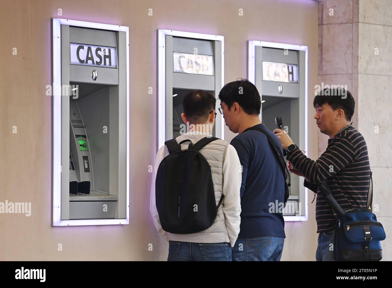 Asiatische Touristen Stehen Vor Einem Bankomat In Muenchen Geldautomat Asiatische Touristen Stehen Vor Einem Bankomat In Muenchen Geldautomat