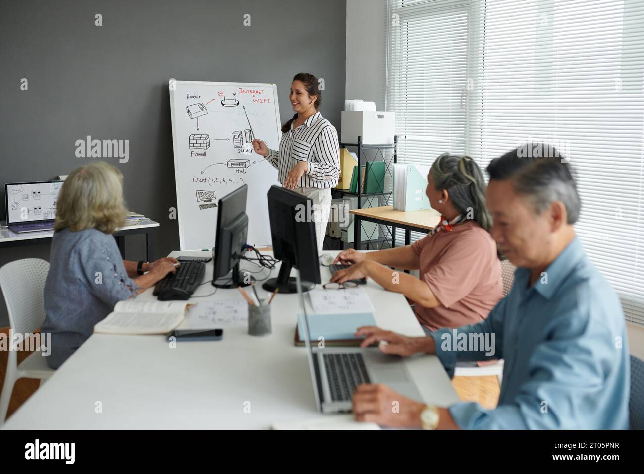 Teacher pointing on whiteboard with scheme when talking about wifi and ...