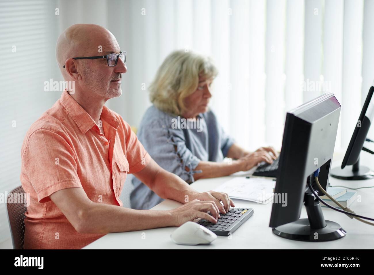 Mature man attending computer class for advanced users Stock Photo - Alamy