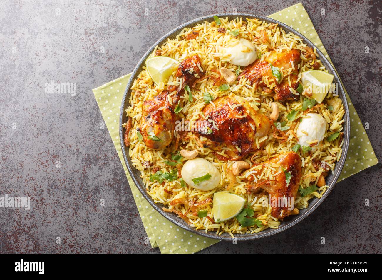 Chicken pulao or Polao with fried onion, egg, nut and raisins closeup ...