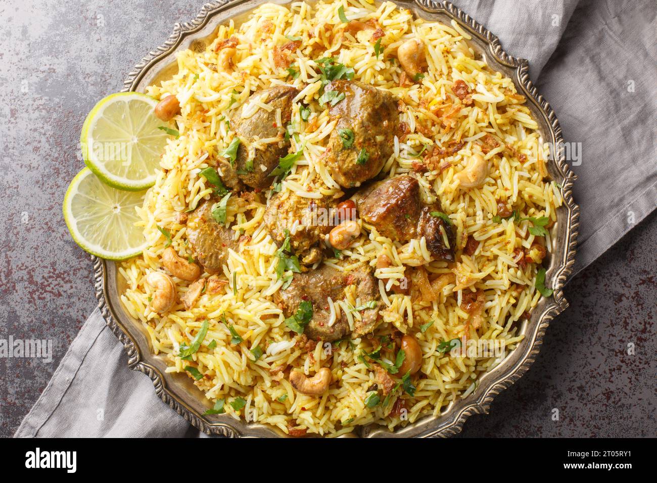 Hot delicious Kacchi Biryani with nuts, raisins, fried onion closeup on ...