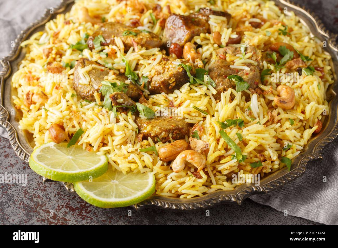 Festive pilaf Kacchi Mutton Biryani with nuts, raisins, fried onion ...