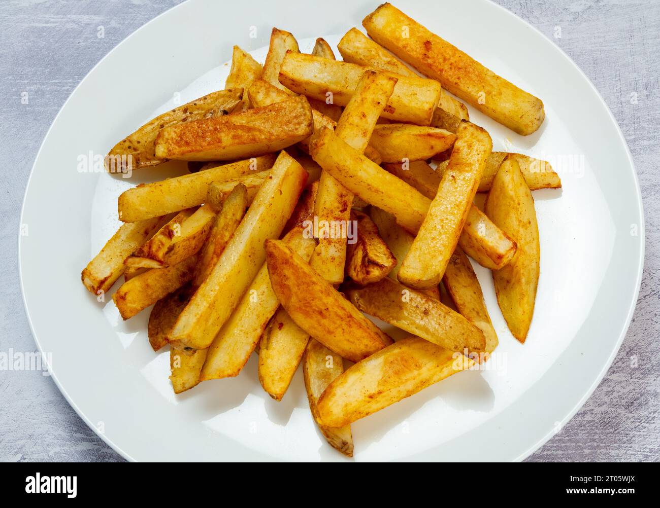 Home made skin on oven baked chips Stock Photo - Alamy