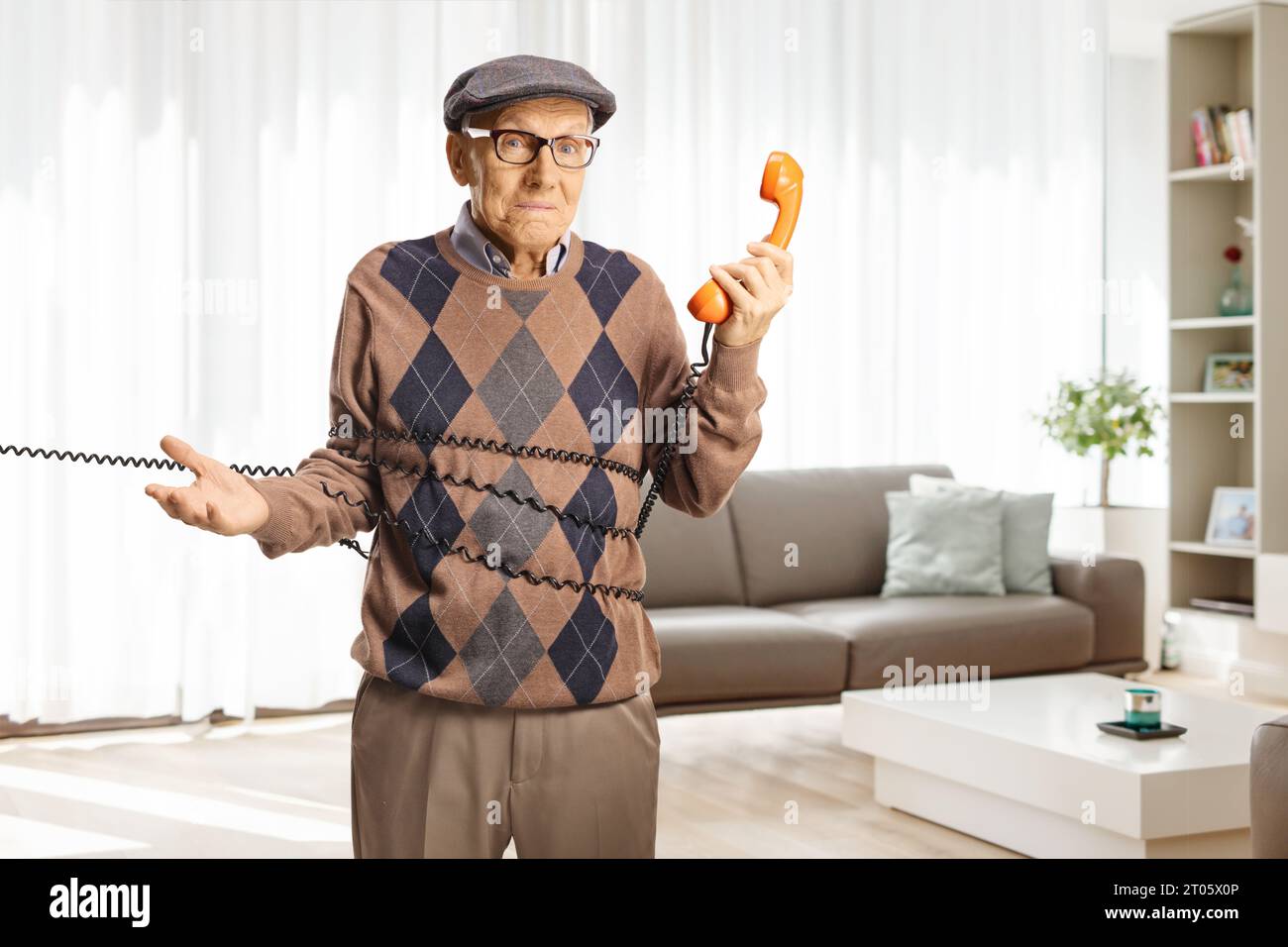 Confused Elderly Man Standing Tangled In A Cable From A Vintage Rotary