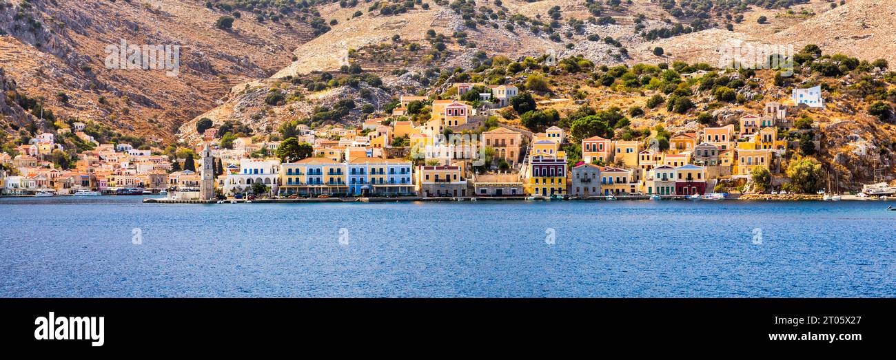 View of the beautiful greek island of Symi (Simi) with colourful houses ...