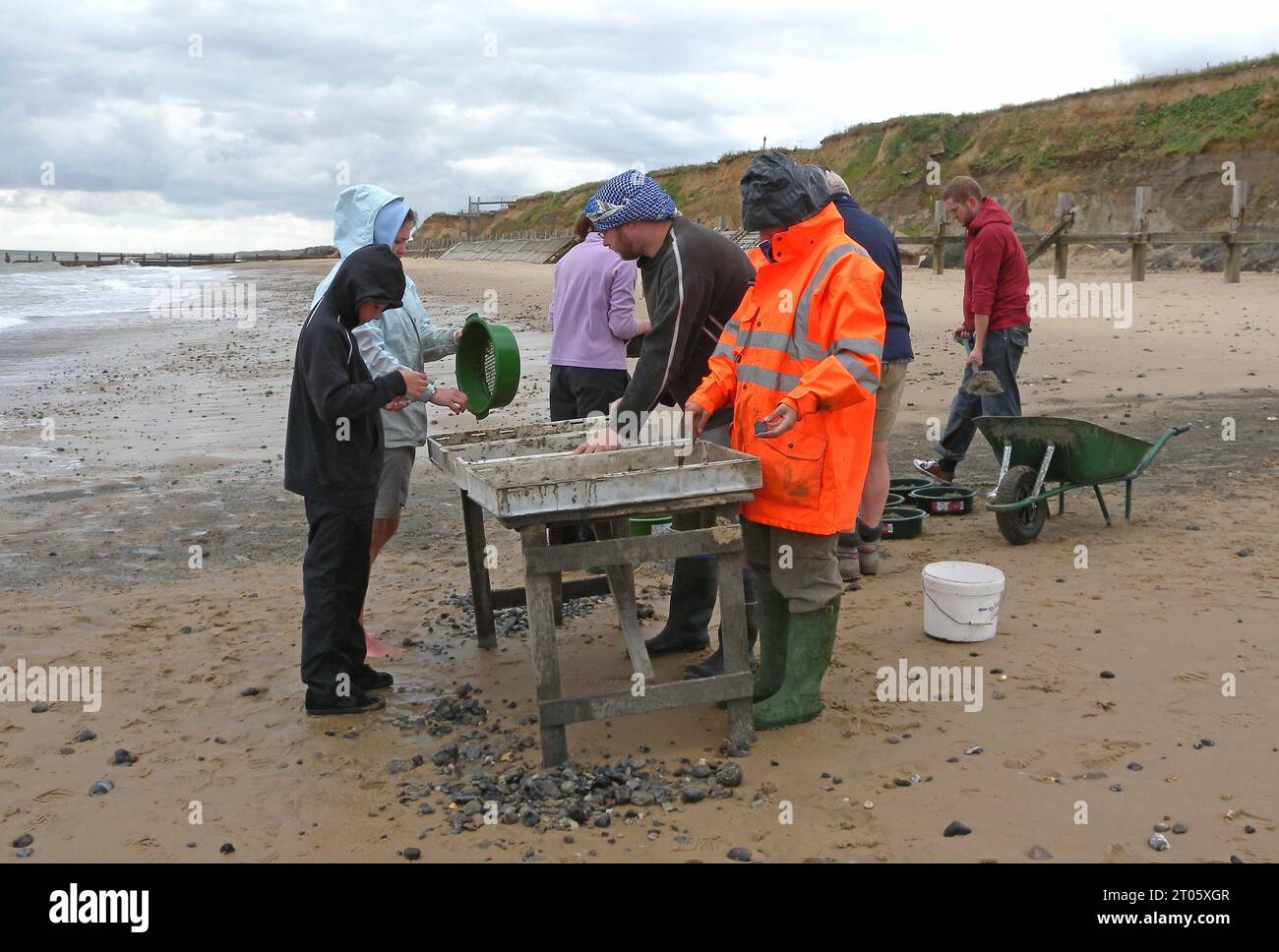 sorting through sieved sediment for finds, oldest human site north of ...