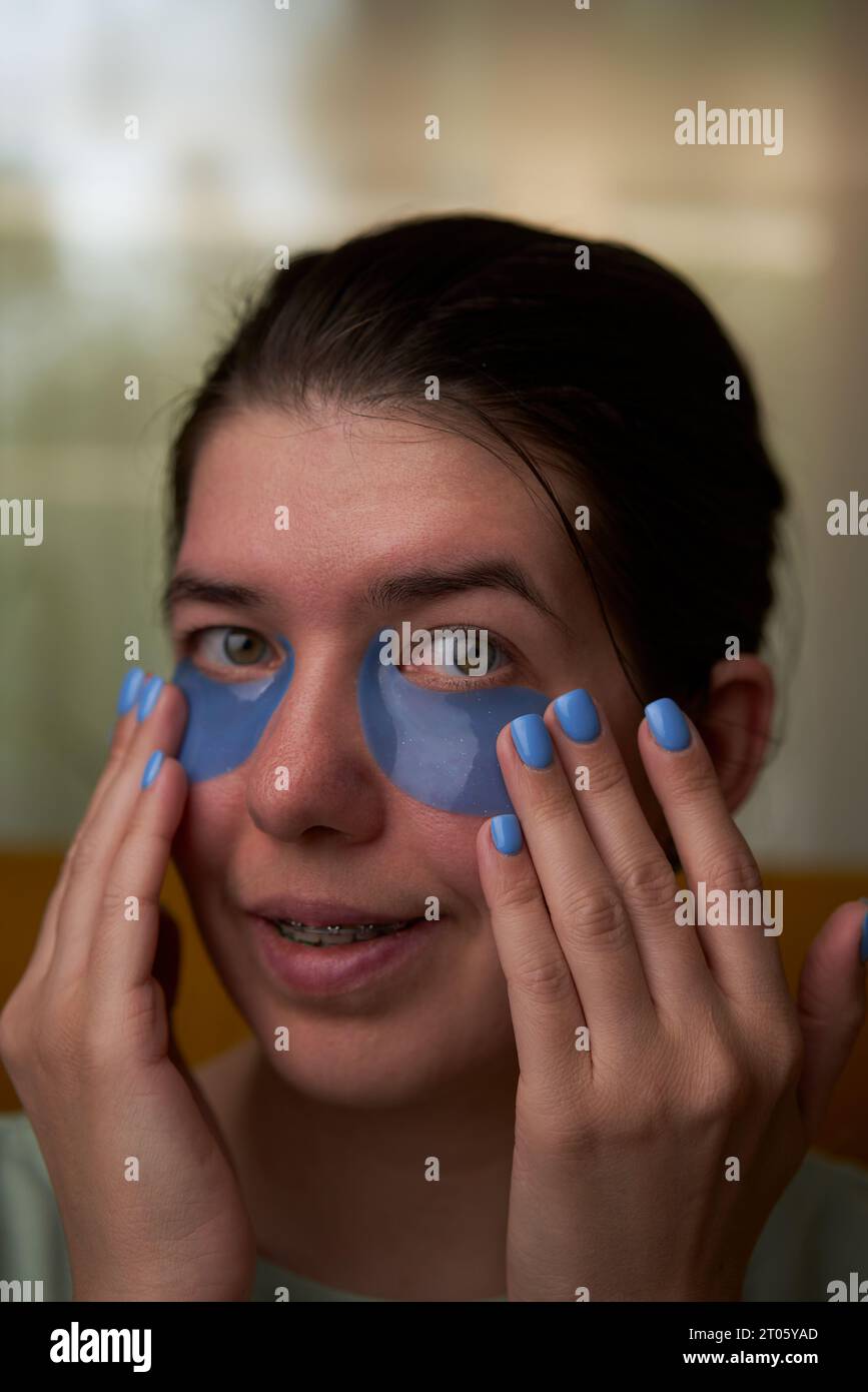 Woman is using cosmetic patches on face. Skin self care and beautiful ...