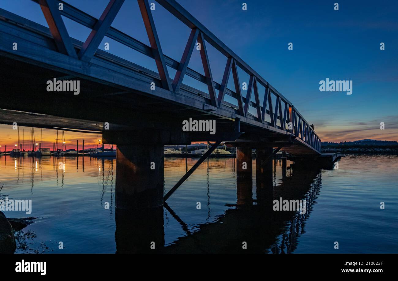 Wooden walkway. Bridge pier walk in sunset. Pier bridge at night time ...