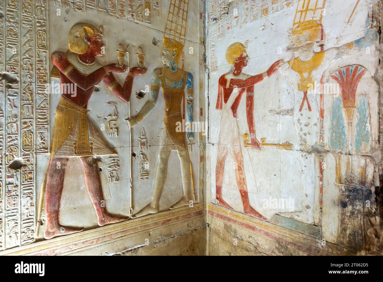 Colorful carved figures and symbols on the walls of the Temple of Seti ...