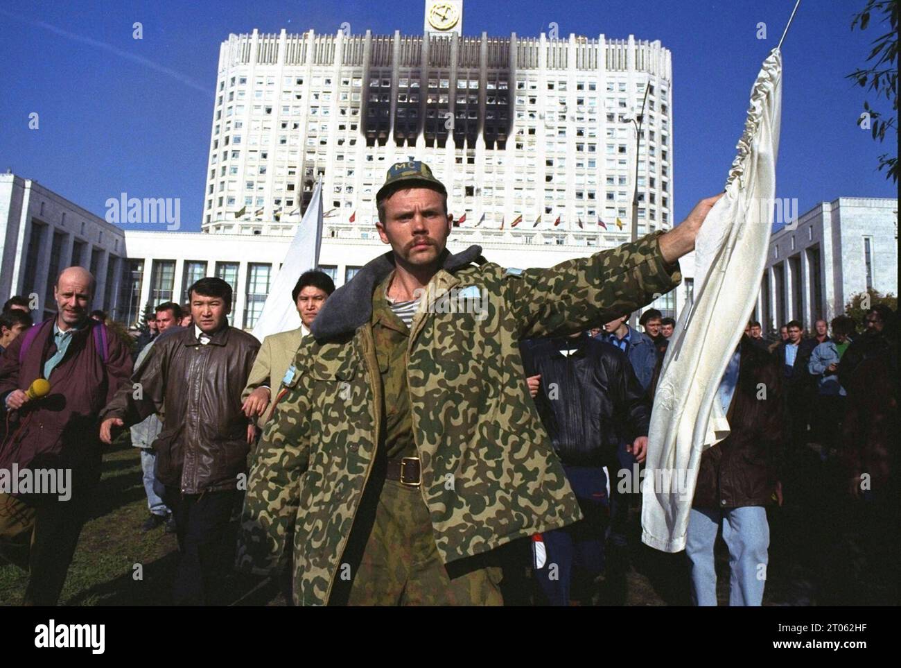 FILE - A hard-line defender of the Russian White House holds up a white ...