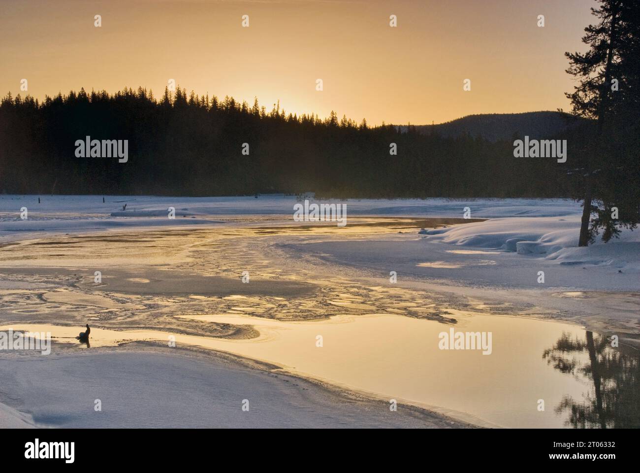 Frozen Paulina Lake in caldera of Newberry Crater volcano at sunrise in ...