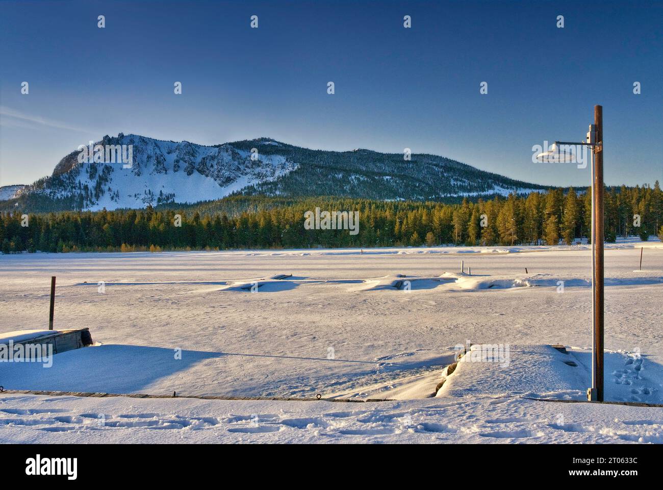 Frozen Paulina Lake in caldera of Newberry Crater volcano at sunrise in ...