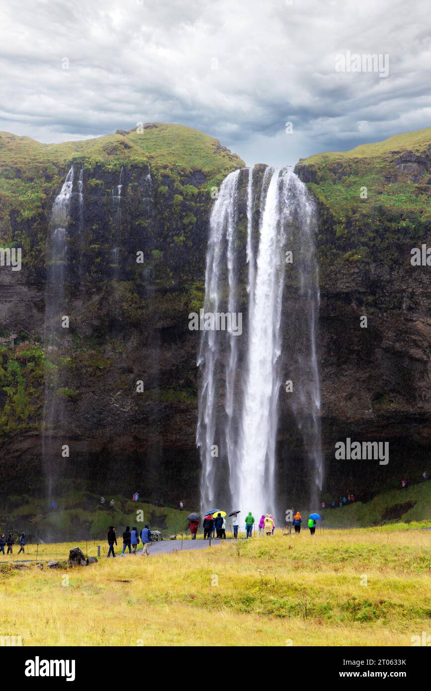 Iceland waterfall; tourists at Seljalandsfoss Waterfall on the Golden ...