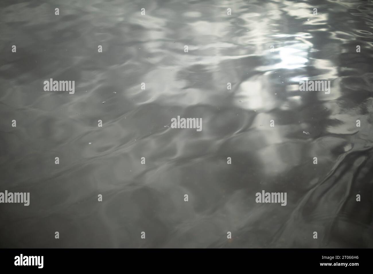 Clouds are reflected in puddle. Cloudy weather outside. Huge puddle on ...