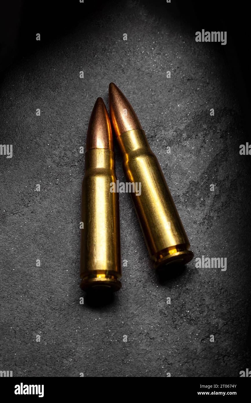 Bullets for Kalashnikov assault rifle on gray concrete background, top ...