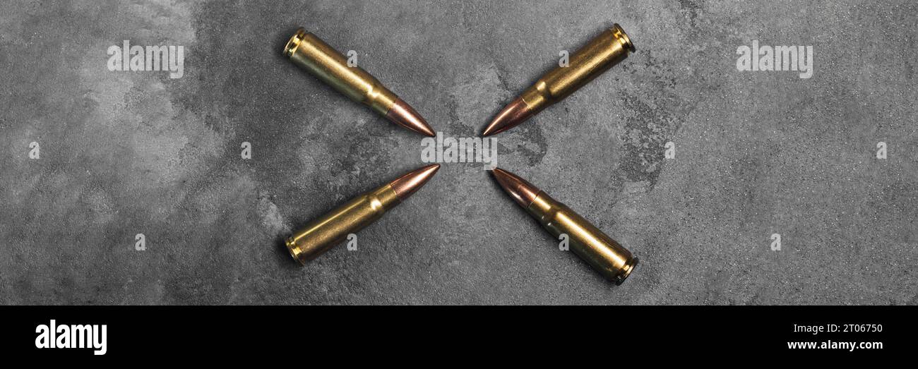 Bullets for Kalashnikov assault rifle on gray concrete and gradient ...
