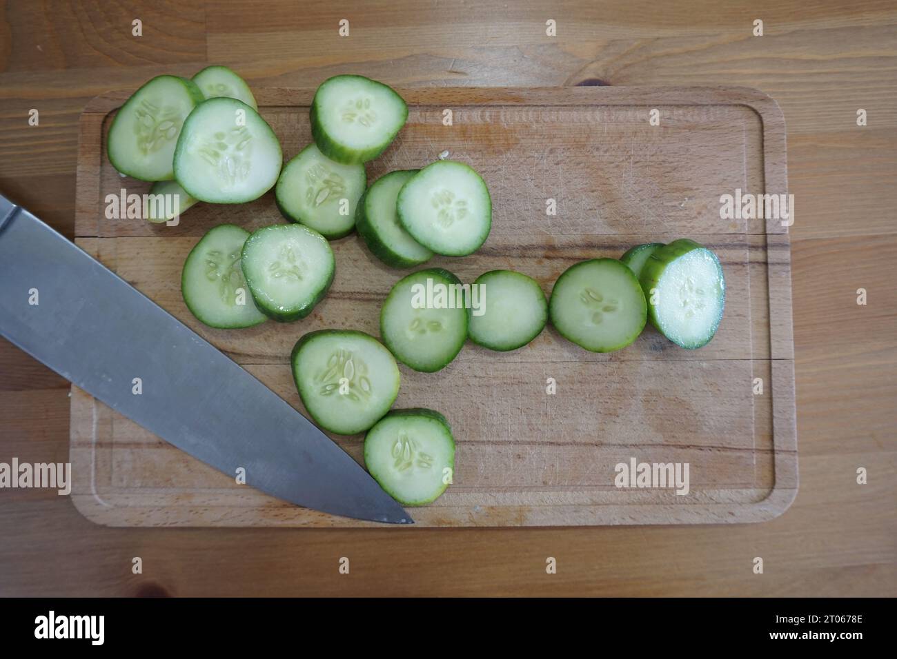 Chef cutting raw cucumber knife hi-res stock photography and images - Alamy