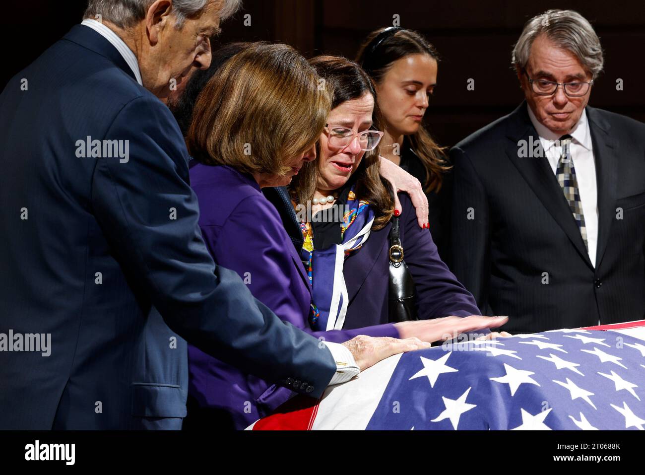 Former House Speaker Nancy Pelosi, second from left, comforts her ...